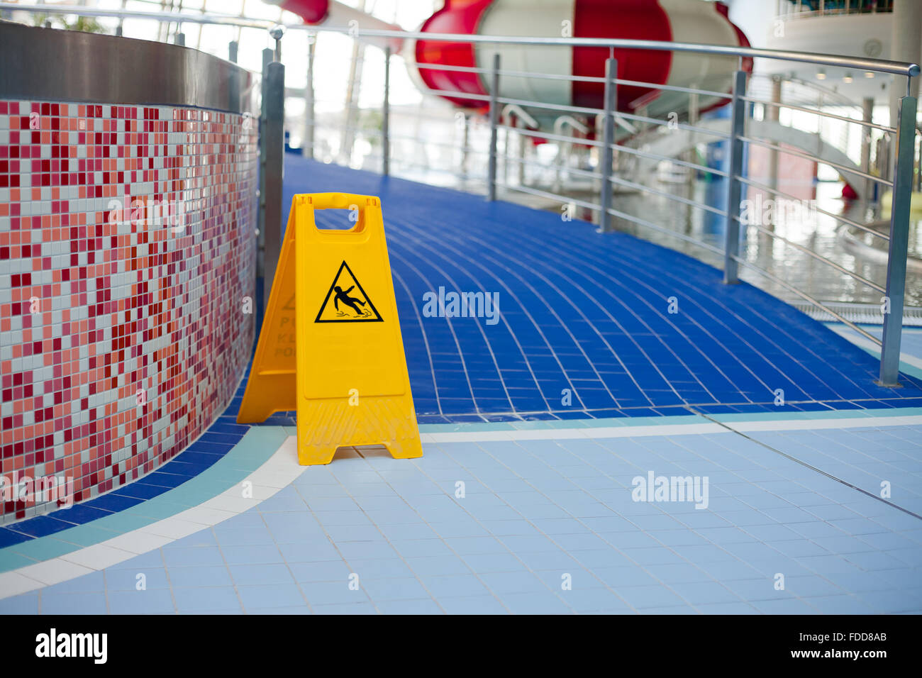Information signs indicating the slippery floor when exiting the pool ...