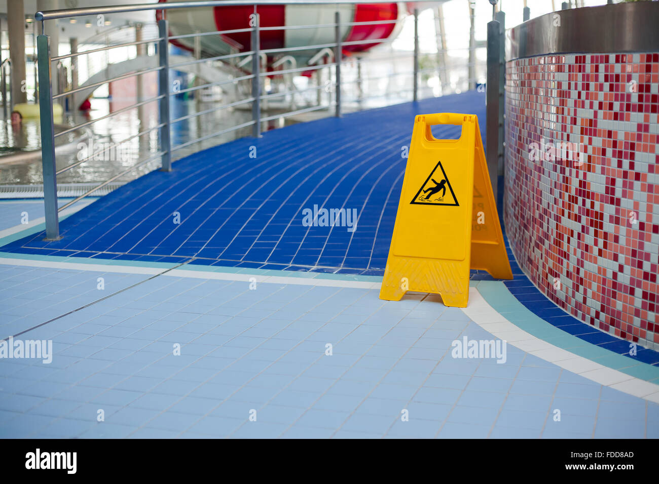 Information signs indicating the slippery floor when exiting the pool ...