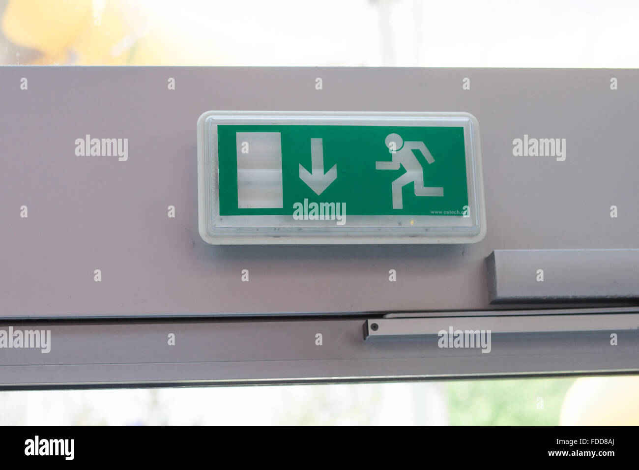 Signs showing the direction of the emergency exit from the building ...