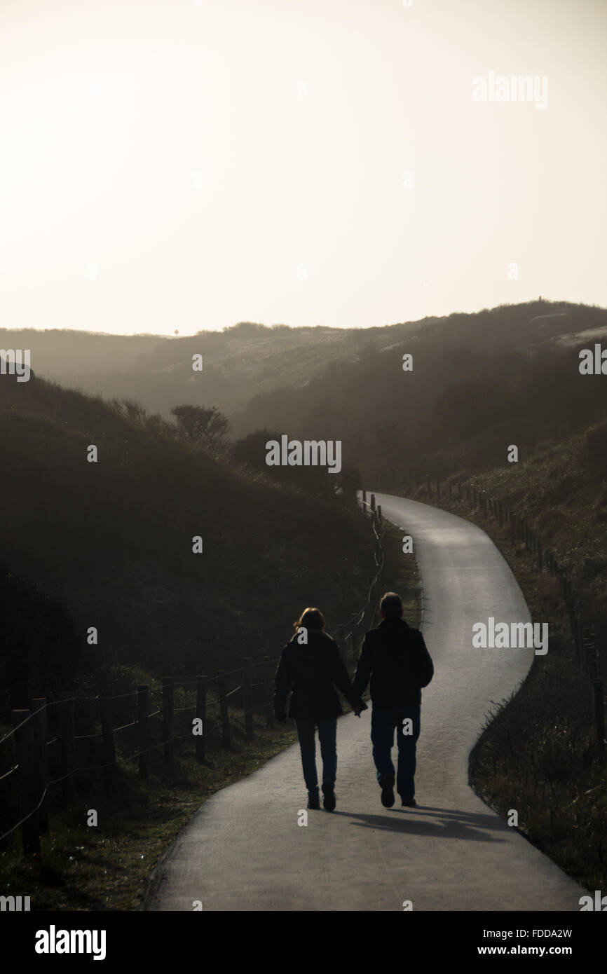 silhouette of couple walking on path Stock Photo - Alamy