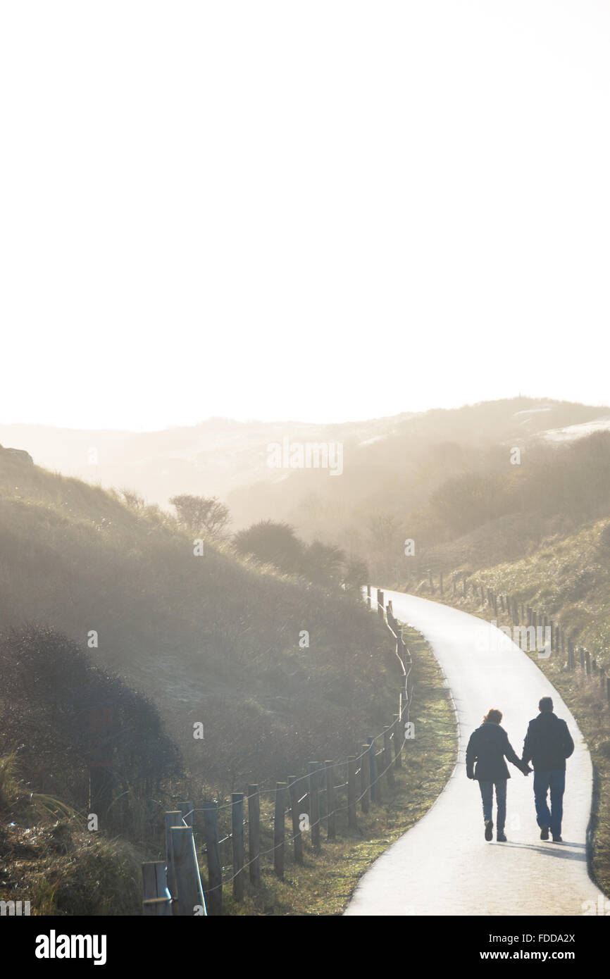 silhouette of couple walking on path Stock Photo - Alamy