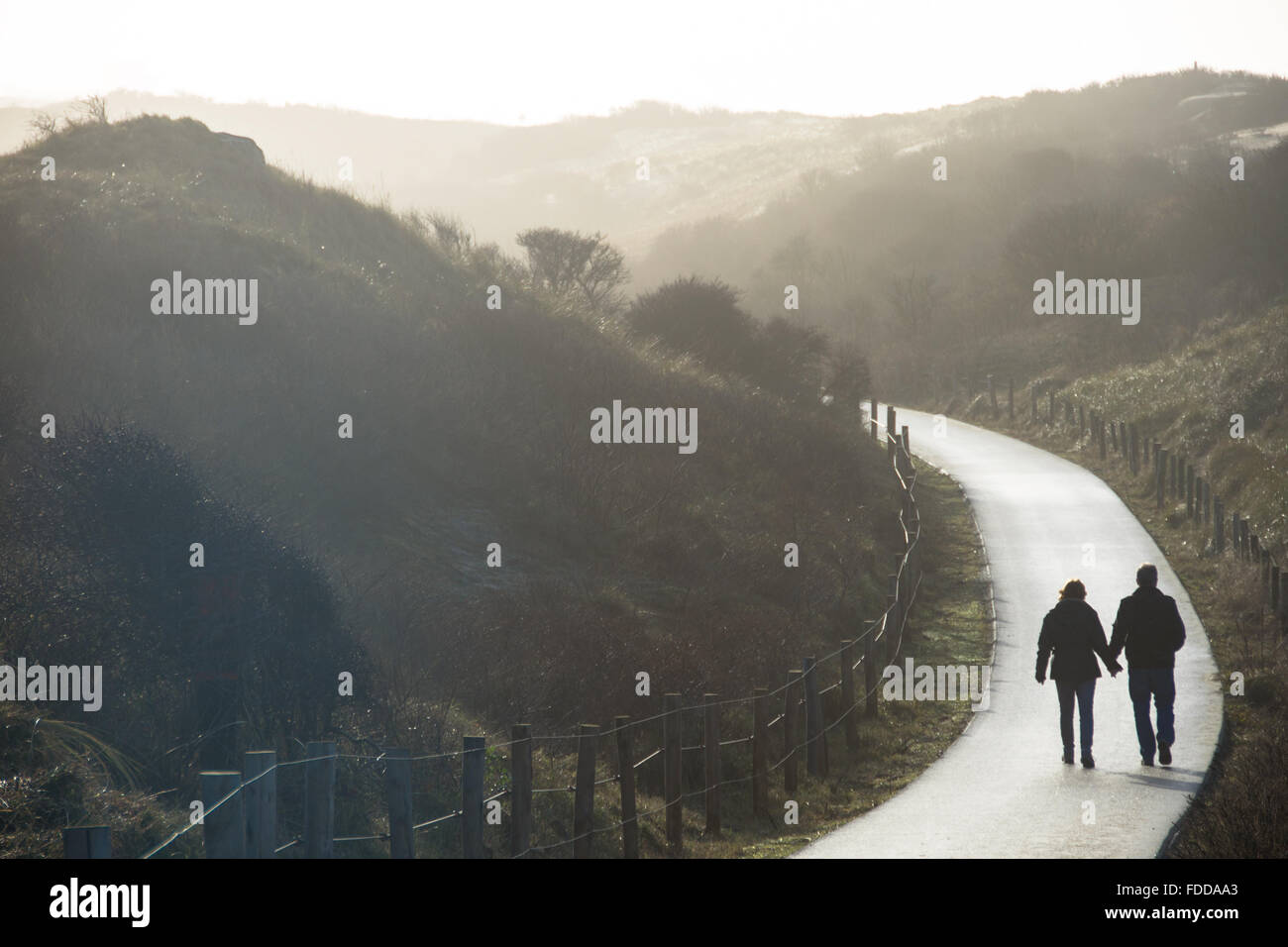 silhouette of couple walking on path Stock Photo - Alamy