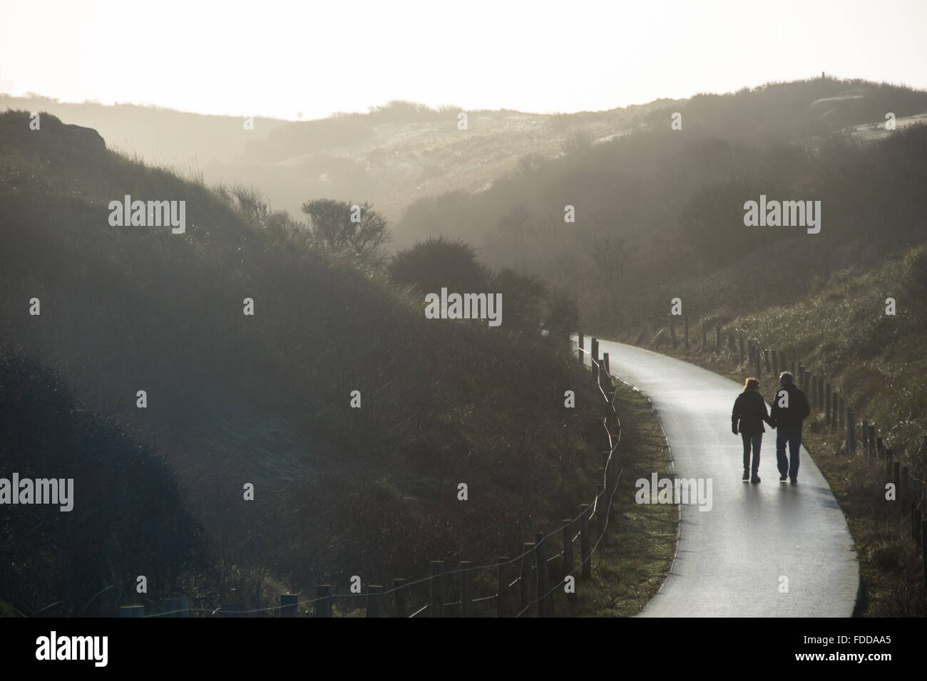 silhouette of couple walking on path Stock Photo - Alamy
