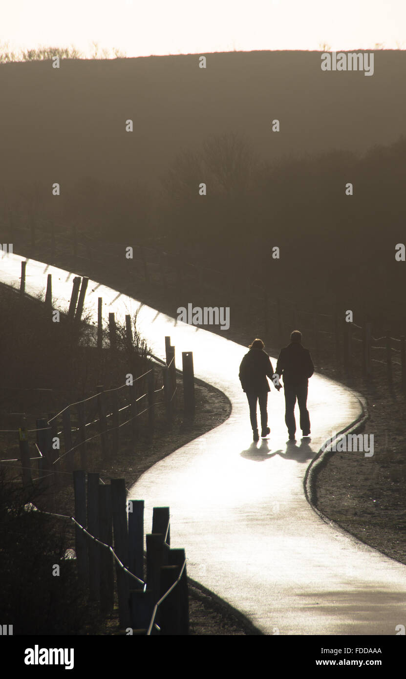silhouette of couple walking on path Stock Photo - Alamy