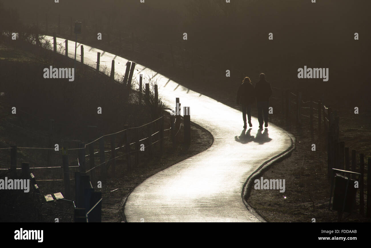 silhouette of couple walking on path Stock Photo - Alamy