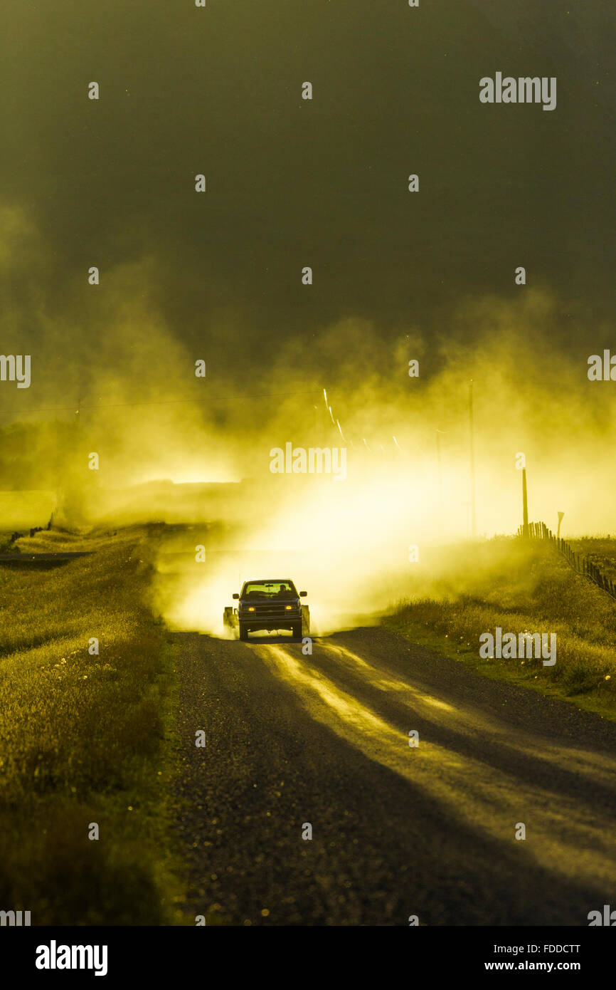vehicle creating dust on country road in Alberta Foothills country ...