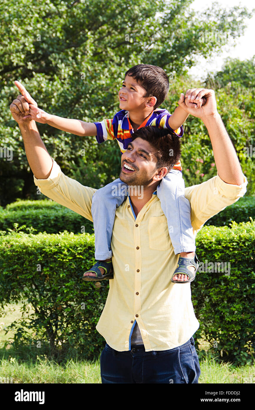 Boy sitting on fathers shoulders hi-res stock photography and images ...