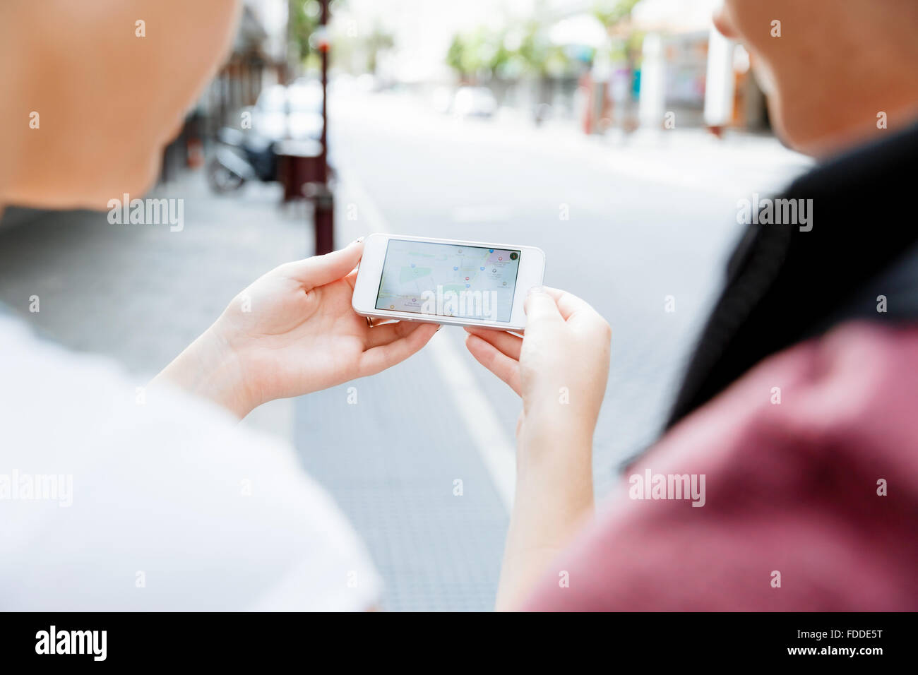 Tourists using navigation app on the mobile phone Stock Photo - Alamy