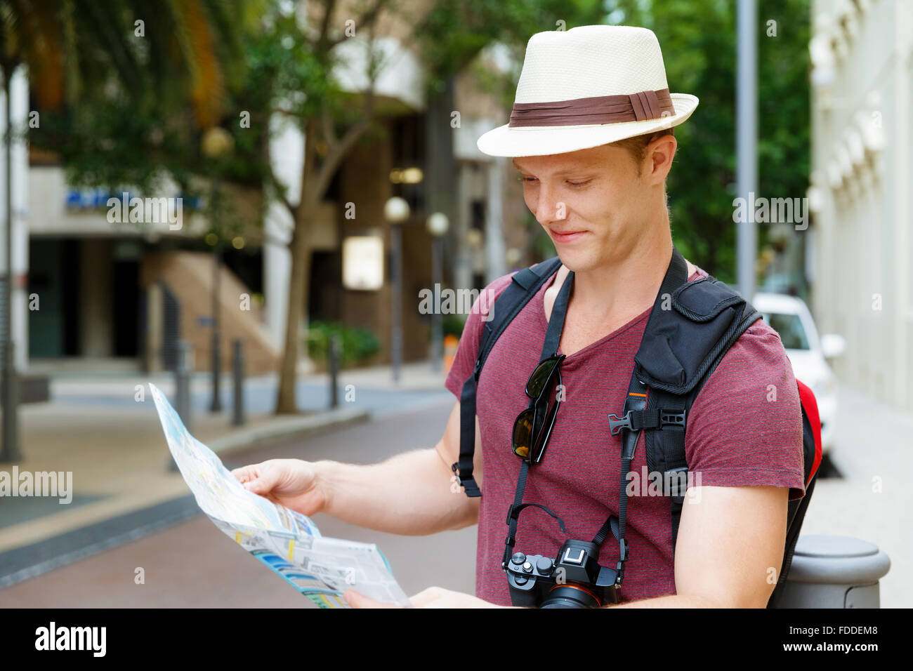 Happy young man with a map Stock Photo - Alamy