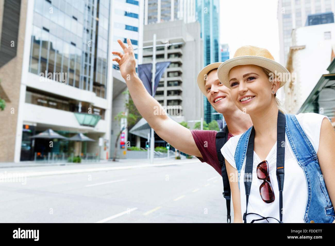 two tourists calling for a taxi in the city Stock Photo - Alamy