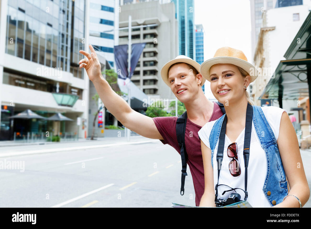 two tourists calling for a taxi in the city Stock Photo - Alamy