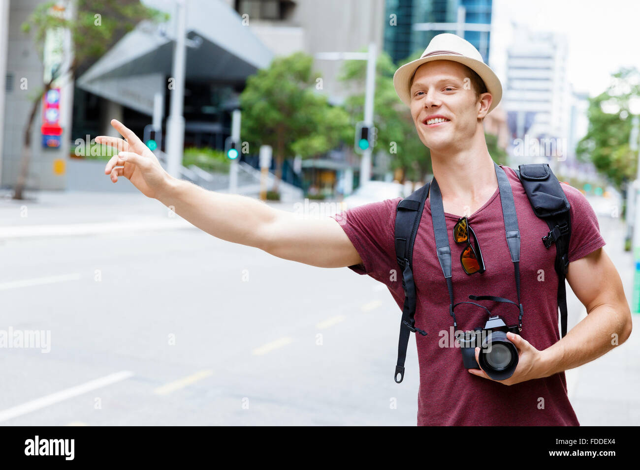 Male tourist calling for a taxi in the city hi-res stock photography ...