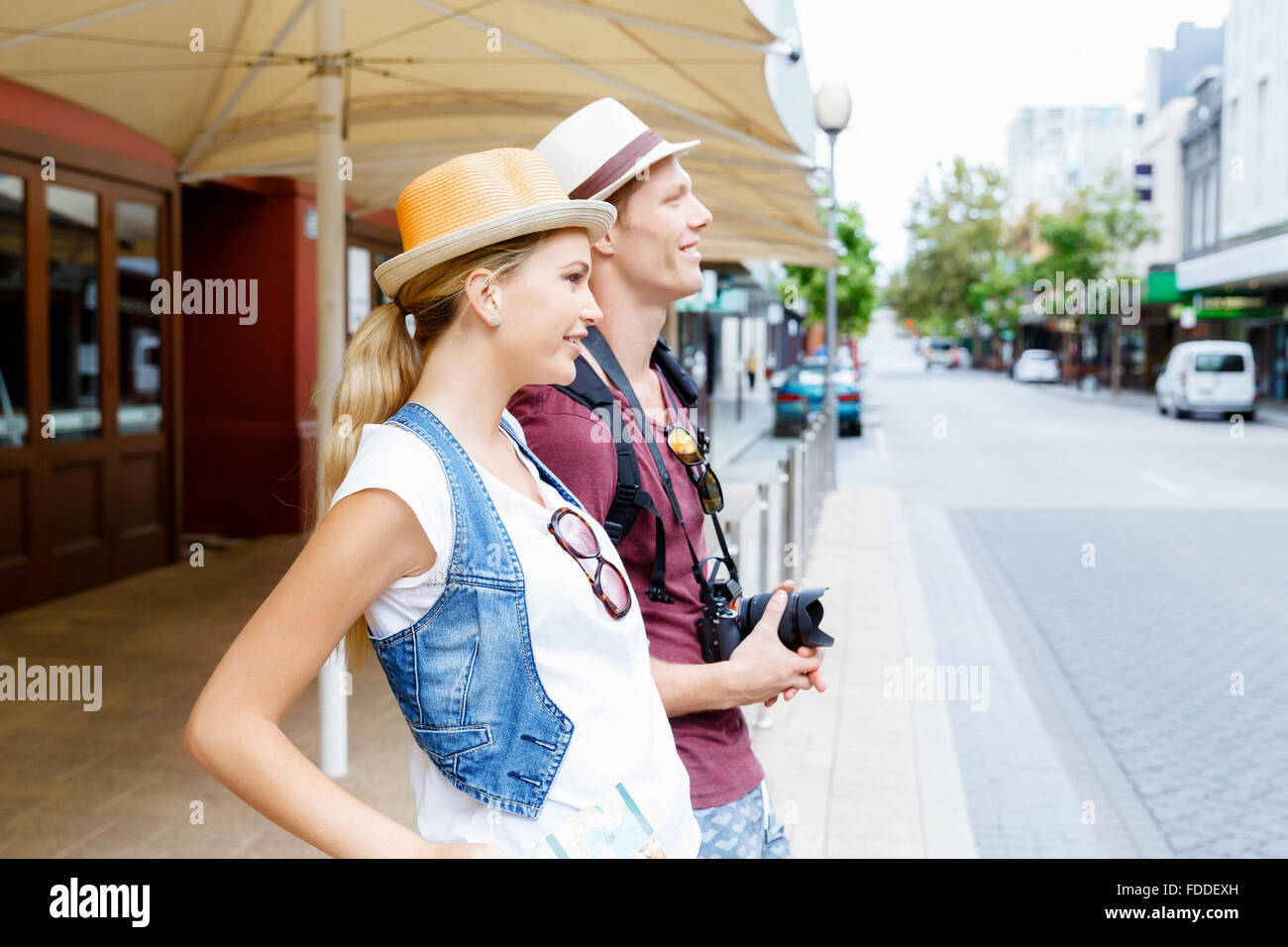 Happy young couple exploring city Stock Photo - Alamy