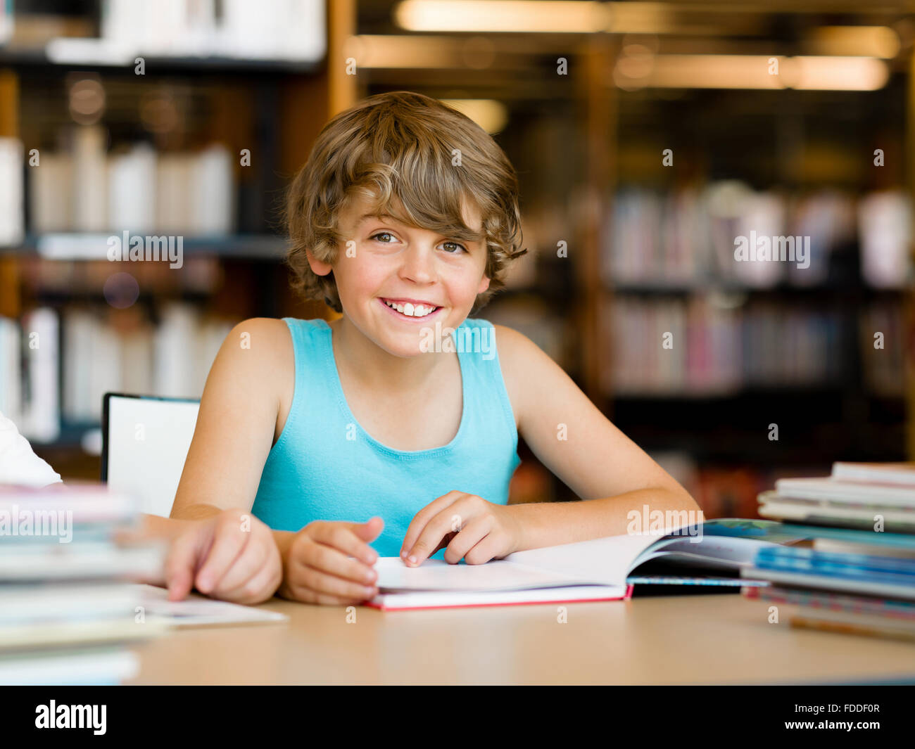 Boy in library with books Stock Photo - Alamy