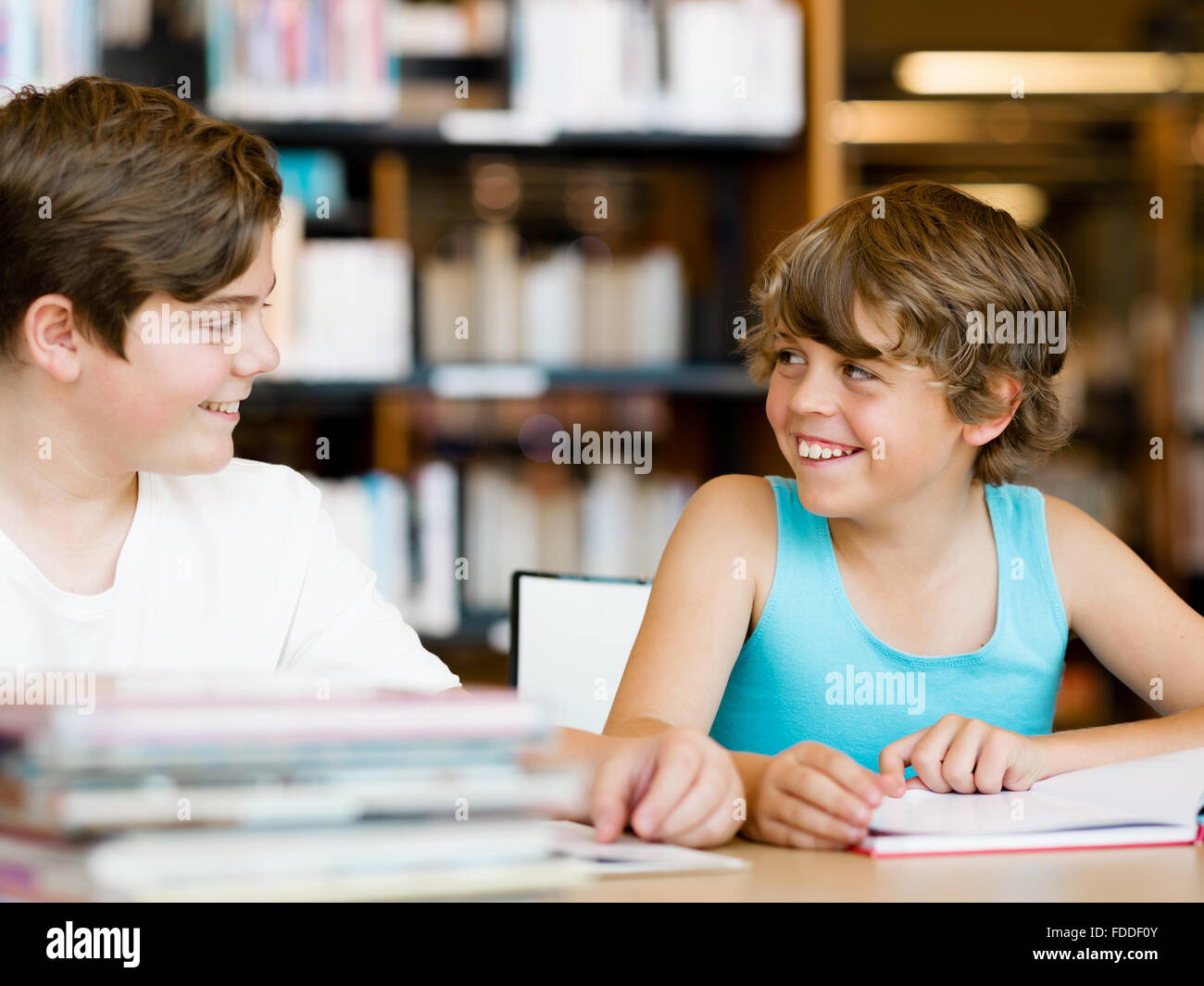 Boy in library with books Stock Photo - Alamy