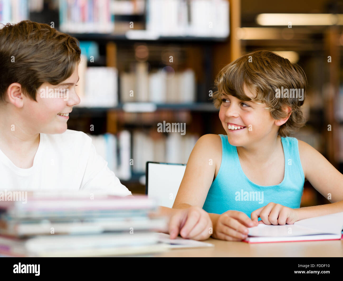 Boy in library with books Stock Photo - Alamy
