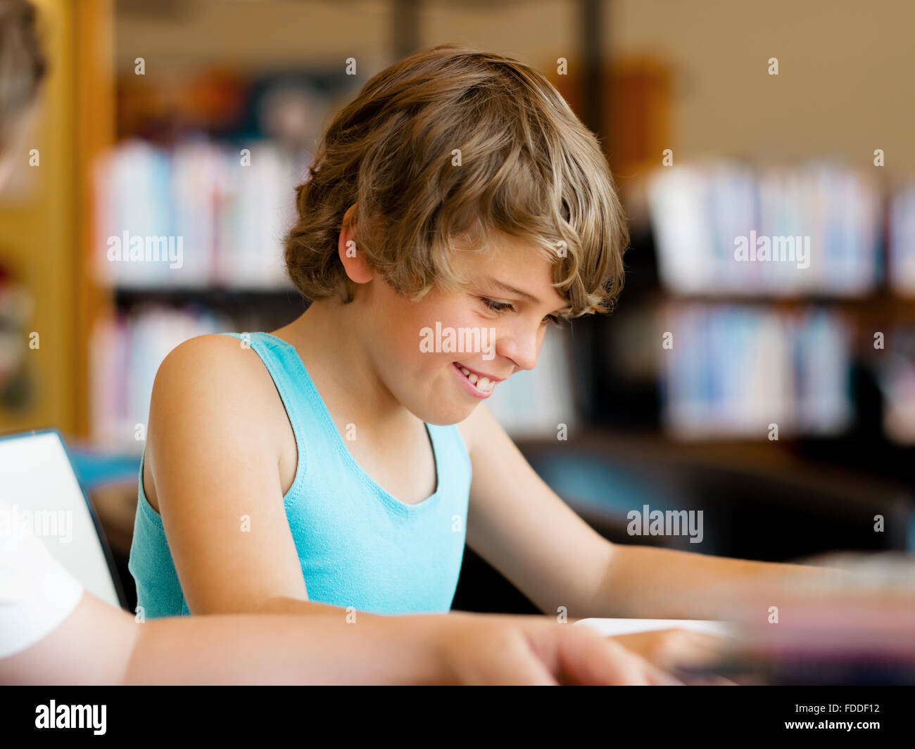 Boy in library with books Stock Photo - Alamy