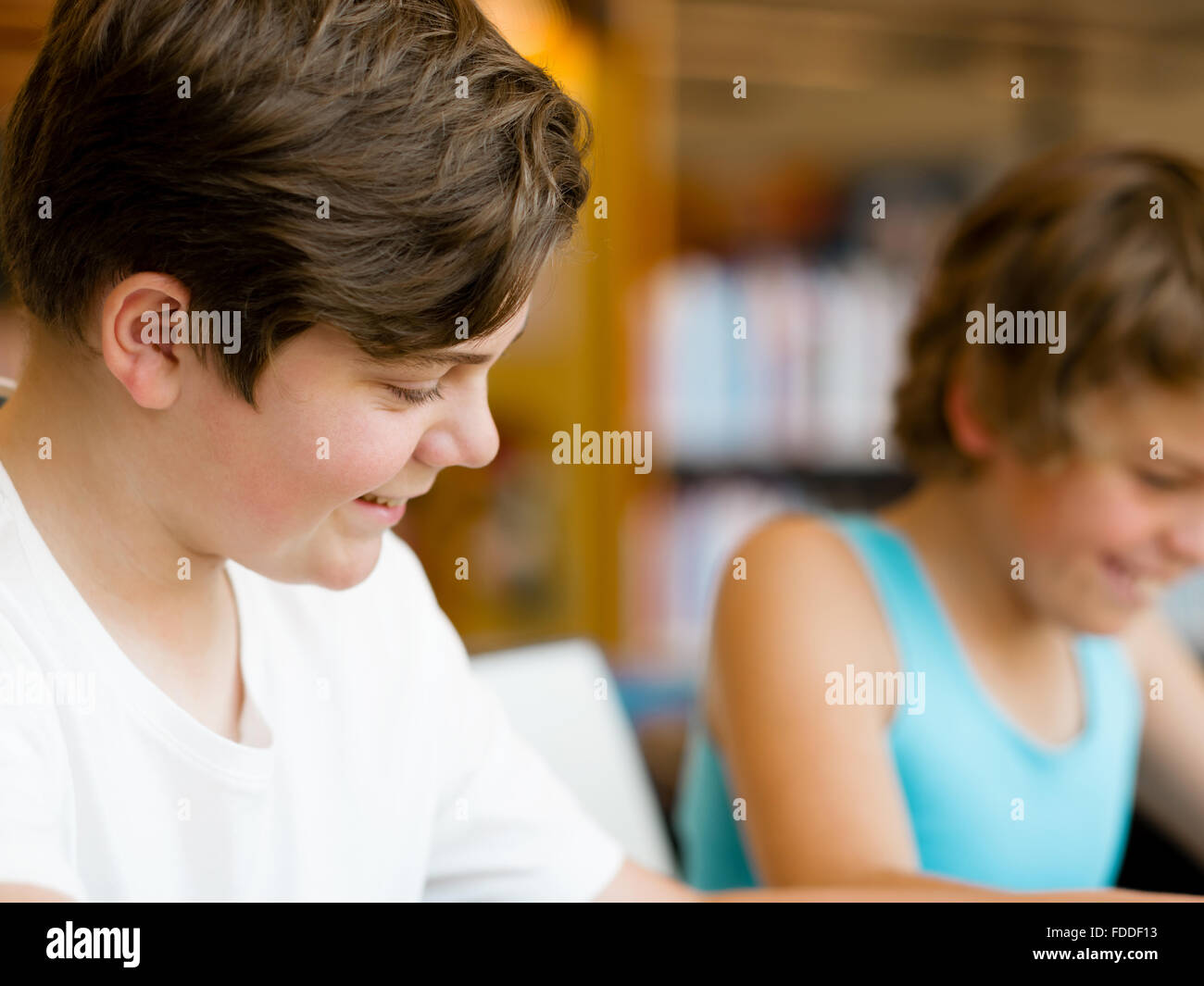 Two boys in library with books Stock Photo - Alamy