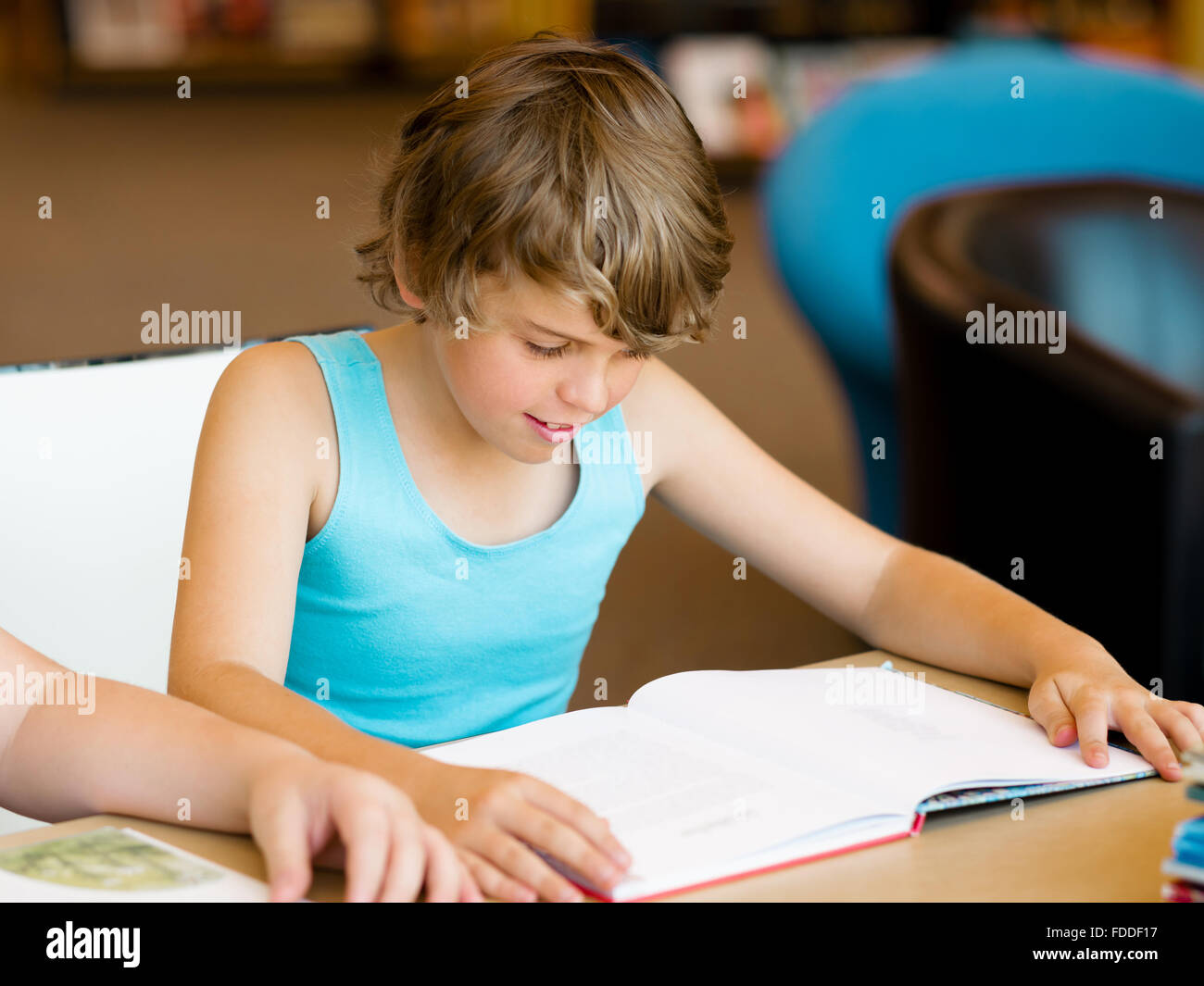 Boy in library with books Stock Photo - Alamy