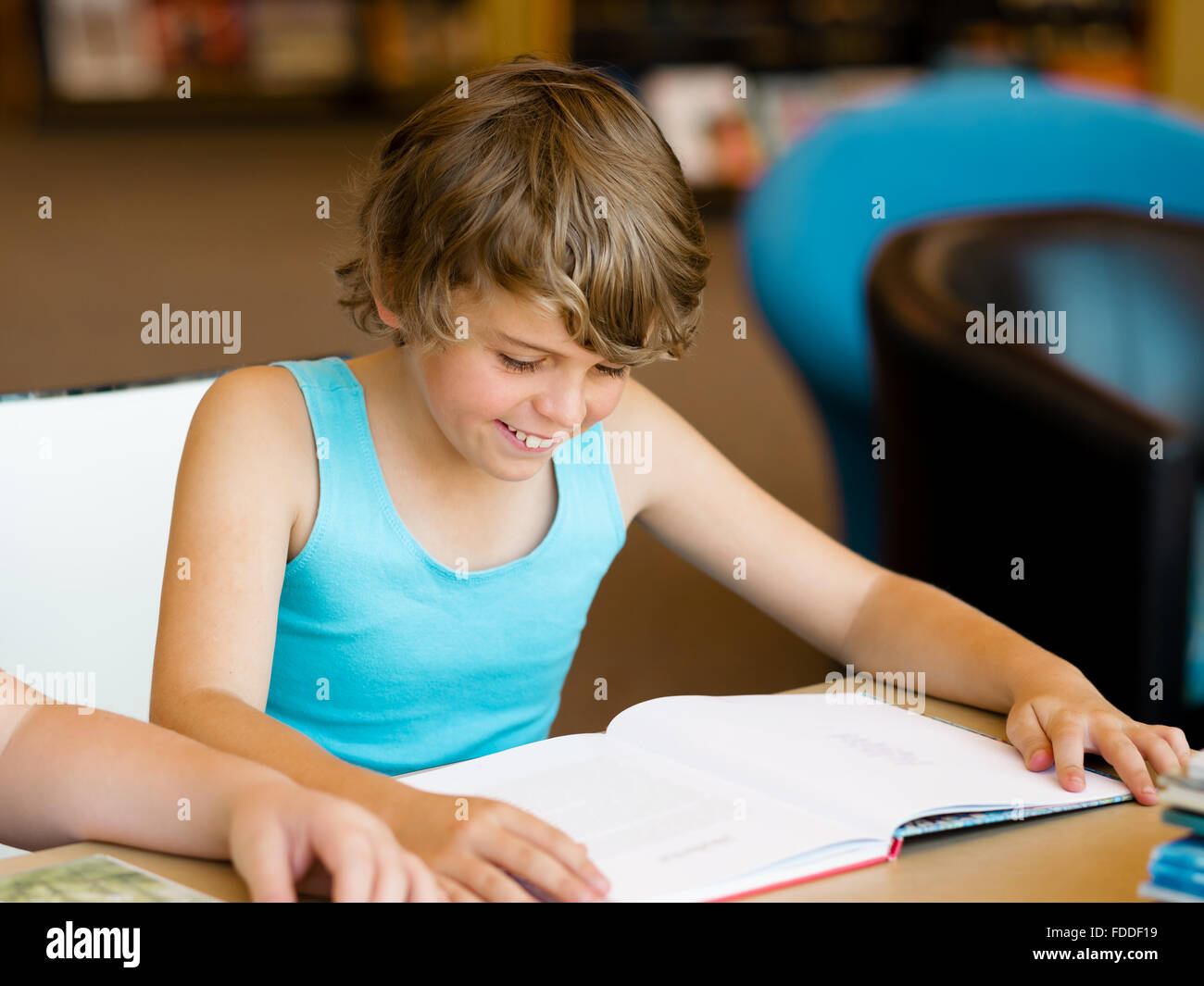 Boy in library with books Stock Photo - Alamy