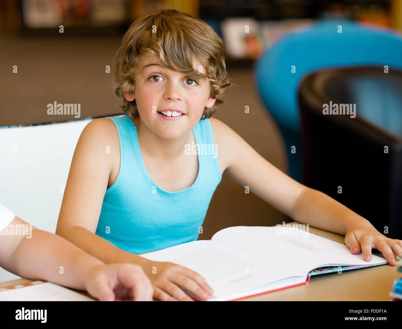 Boy in library with books Stock Photo - Alamy