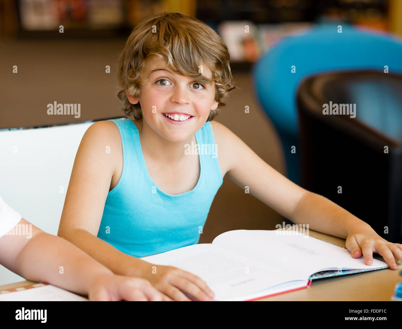 Boy in library with books Stock Photo - Alamy