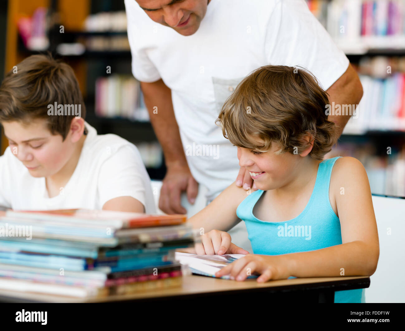 Two boys in library with books Stock Photo - Alamy