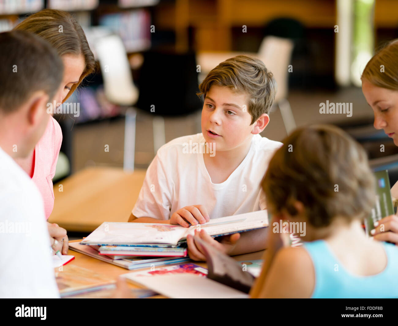 Family in library with books Stock Photo - Alamy