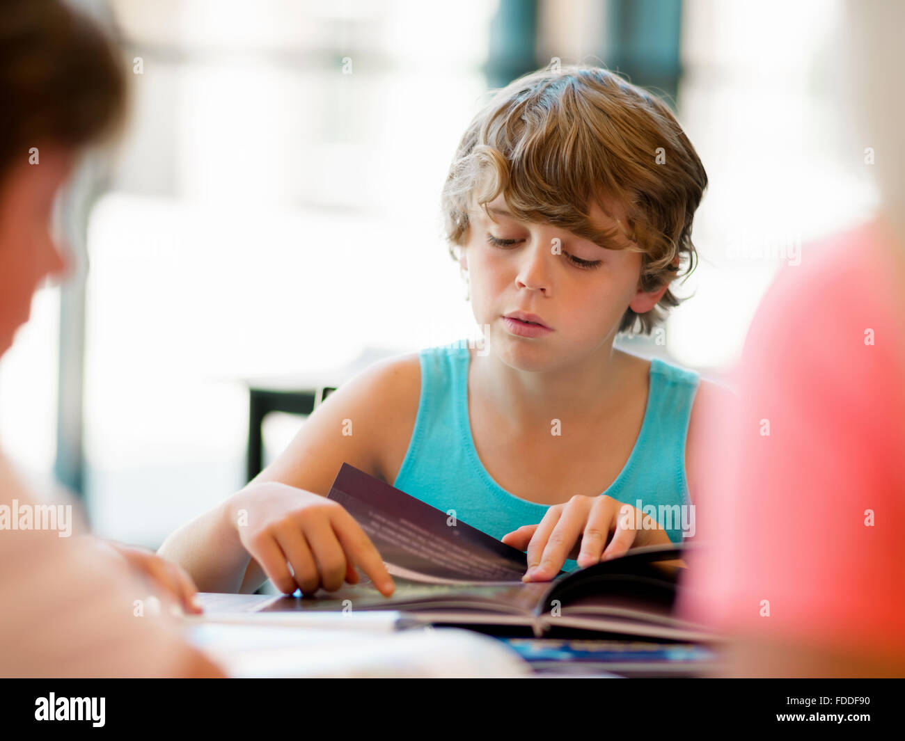 Boy in library with books Stock Photo - Alamy