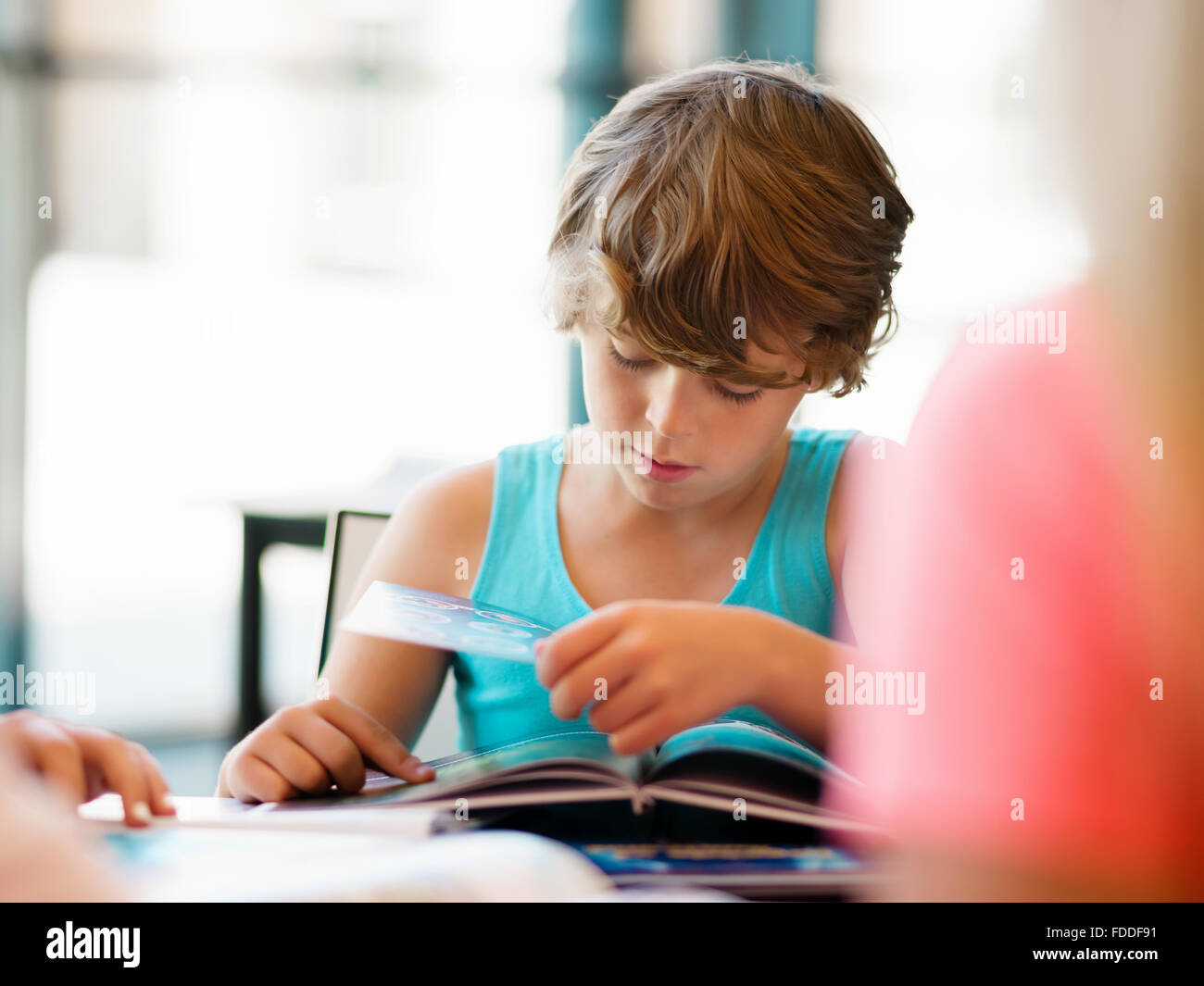 Boy in library with books Stock Photo - Alamy