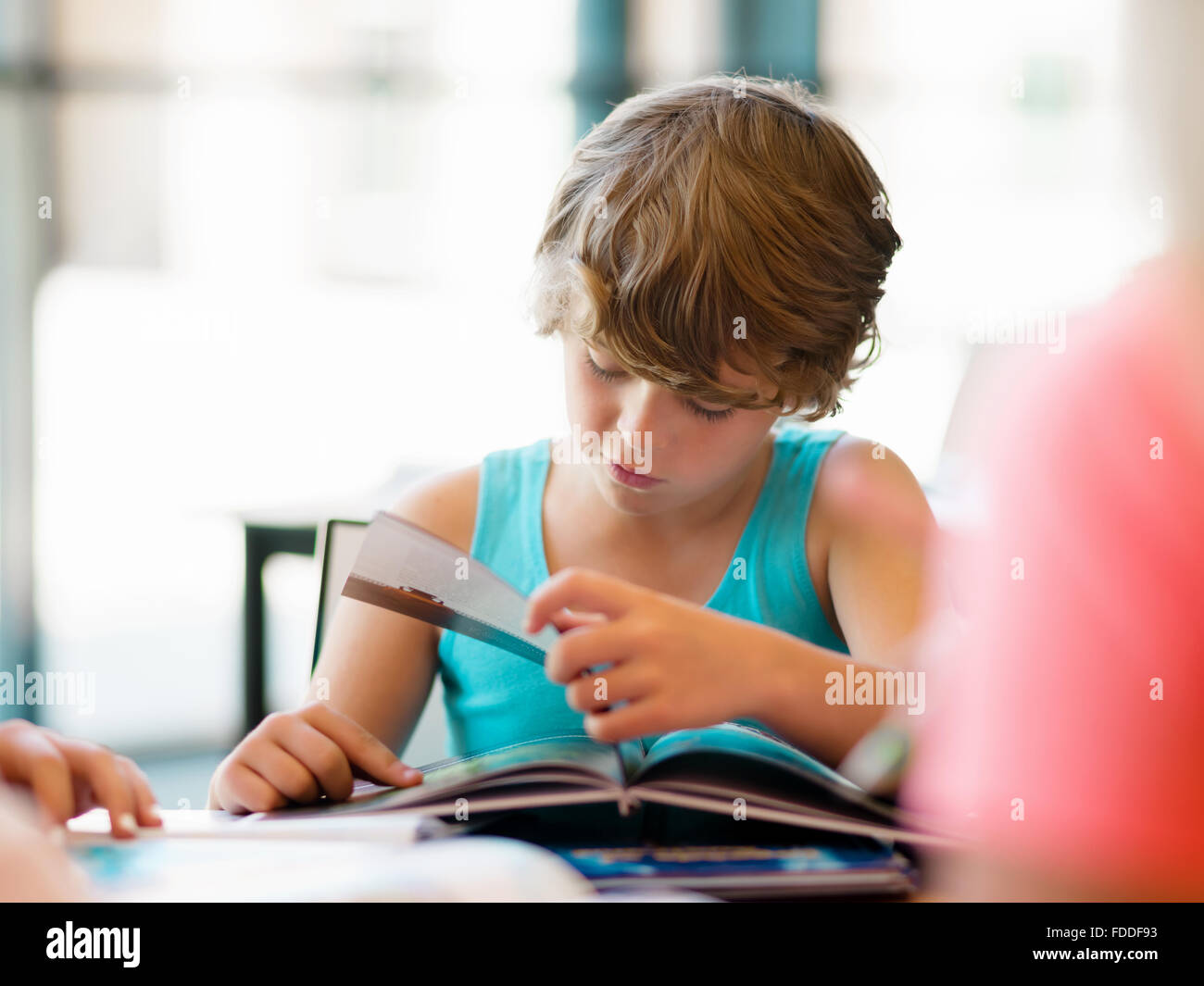Boy in library with books Stock Photo - Alamy