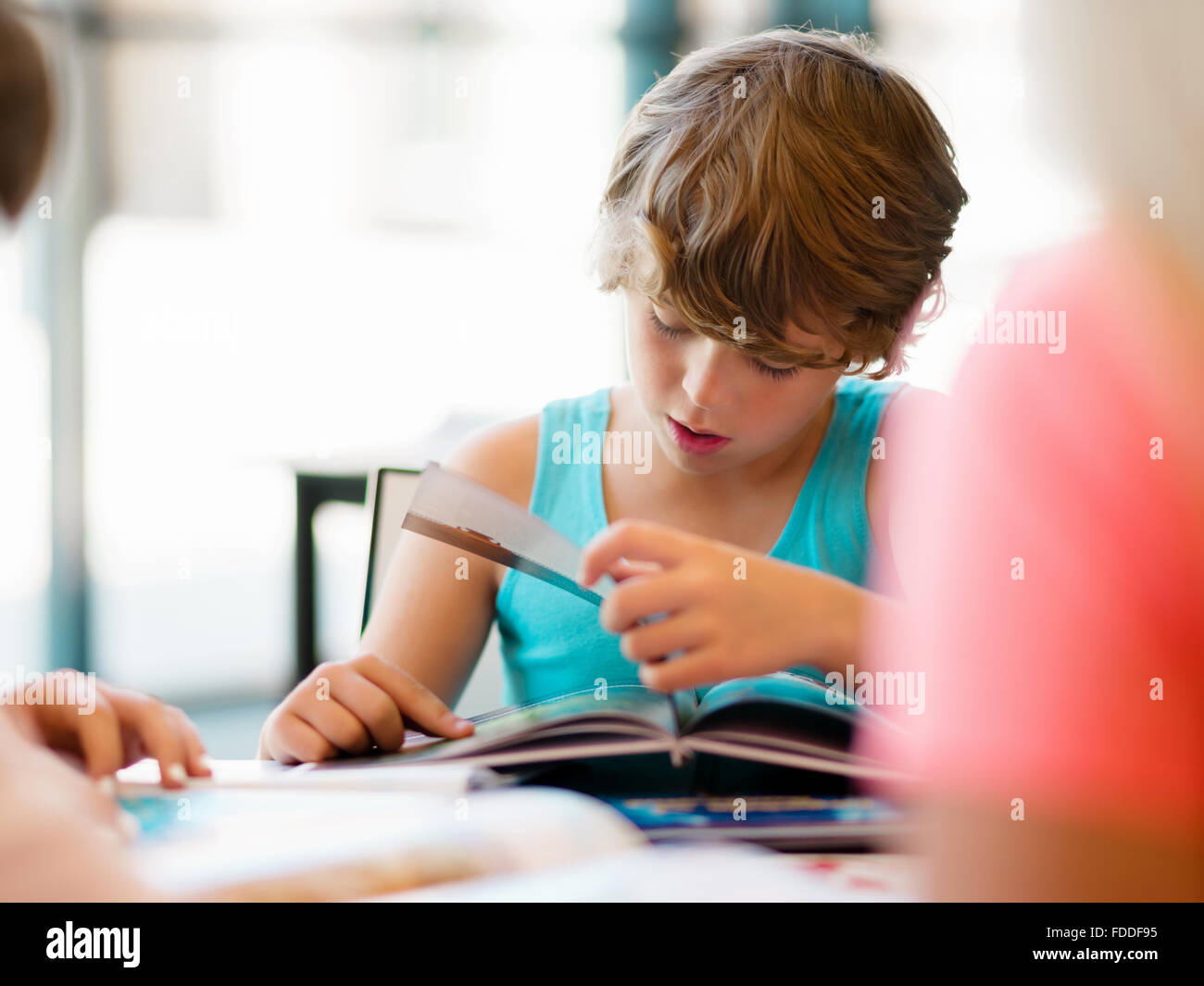 Boy in library with books Stock Photo - Alamy