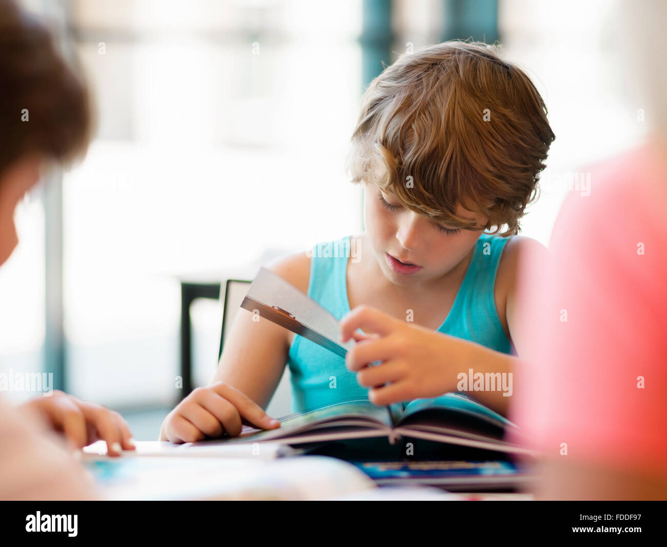 Boy in library with books Stock Photo - Alamy