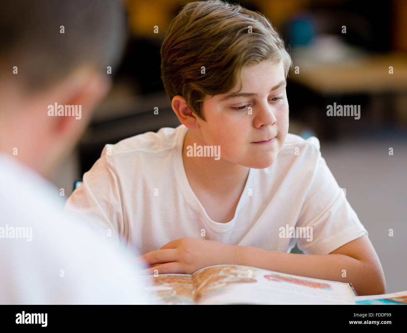 Boy in library with books Stock Photo - Alamy