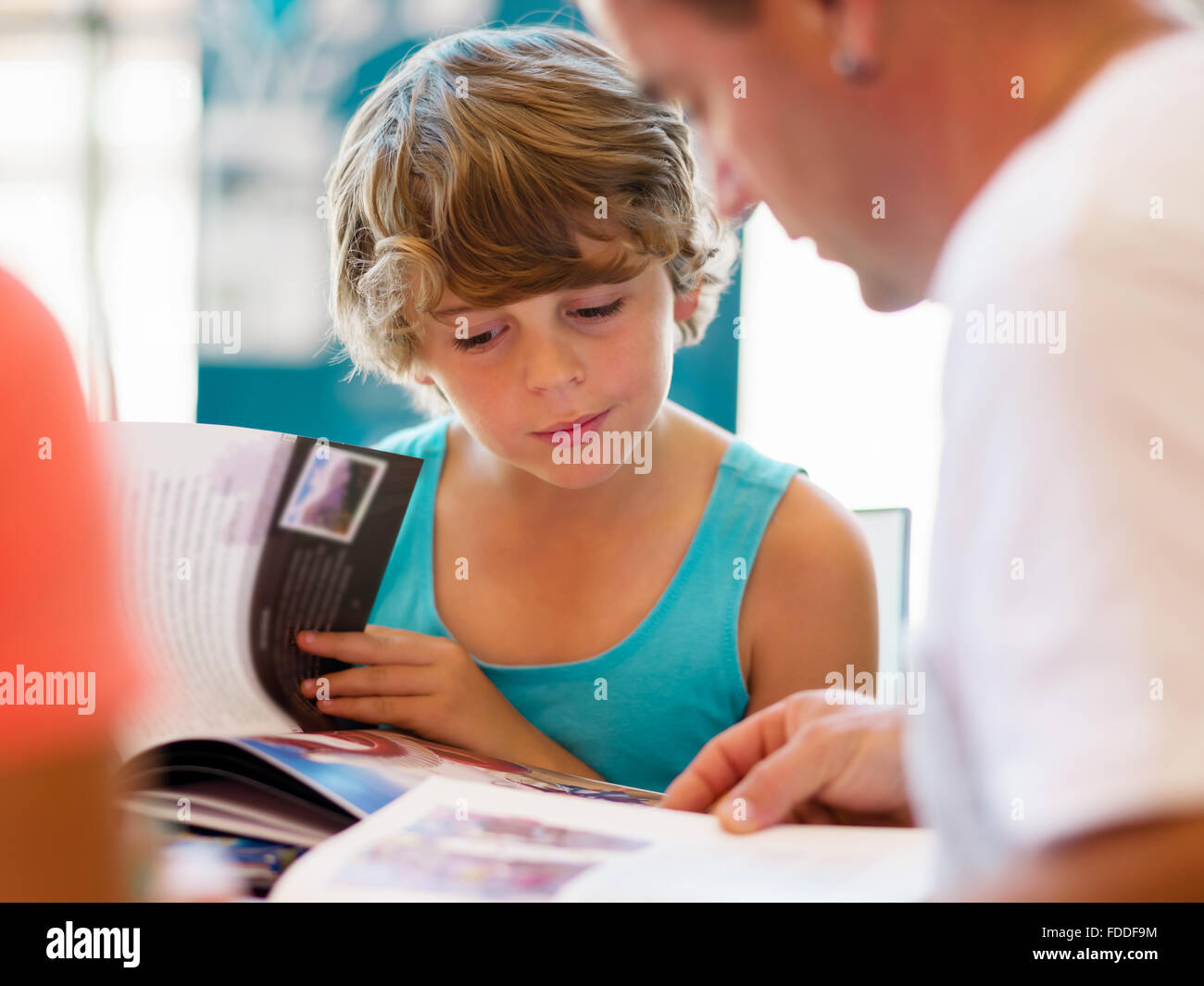 Family in library with books Stock Photo - Alamy