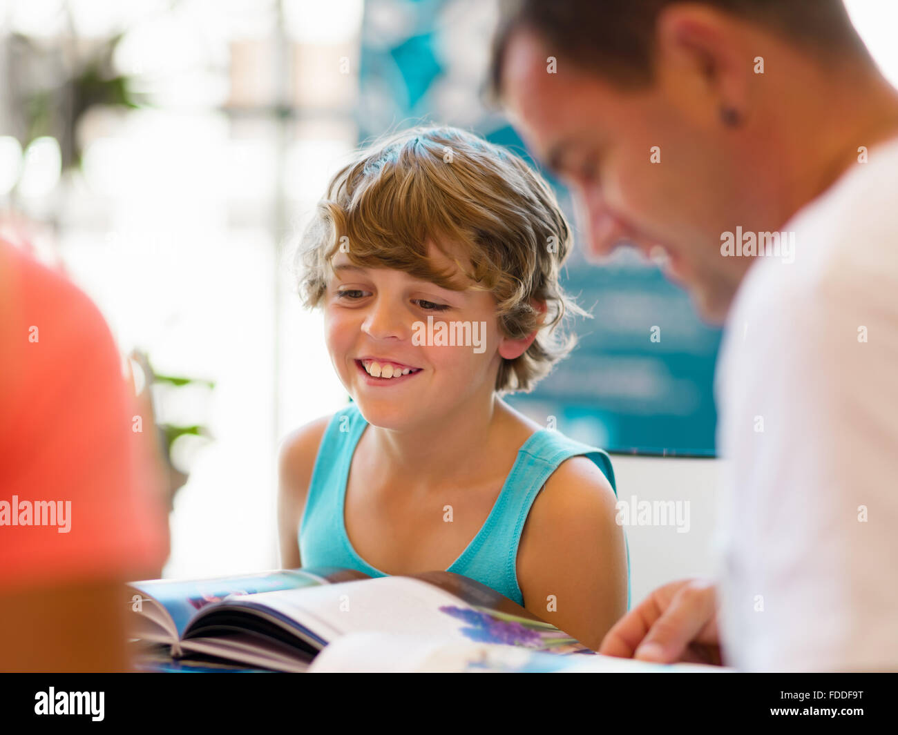 Family in library with books Stock Photo - Alamy