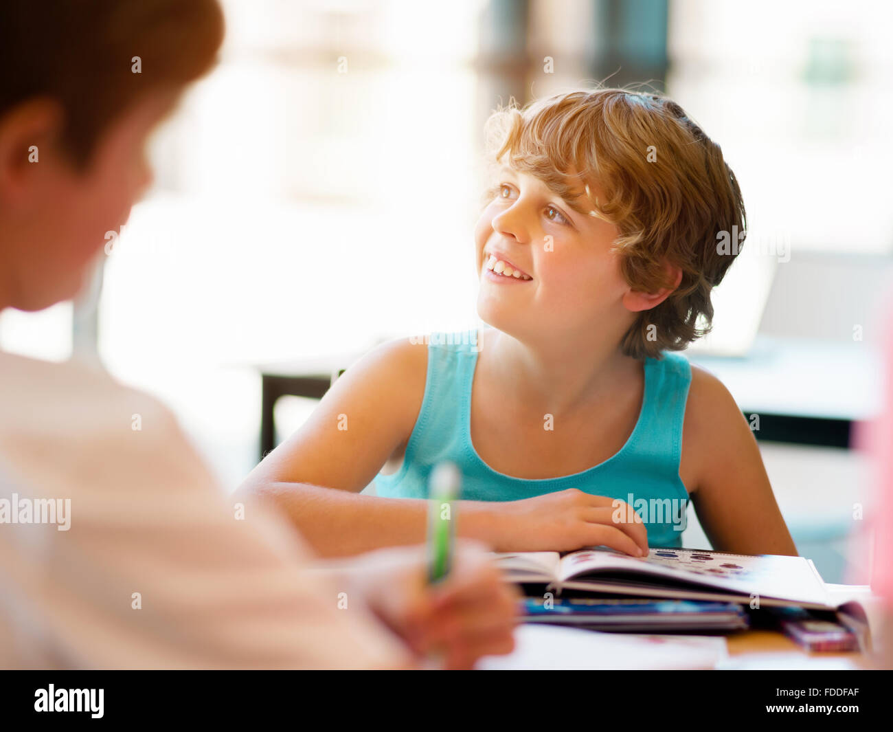 Boy in library with books Stock Photo - Alamy
