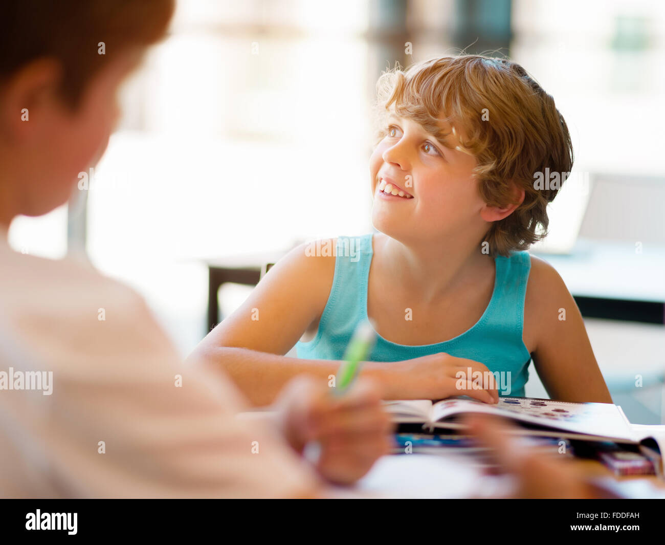 Boy in library with books Stock Photo - Alamy