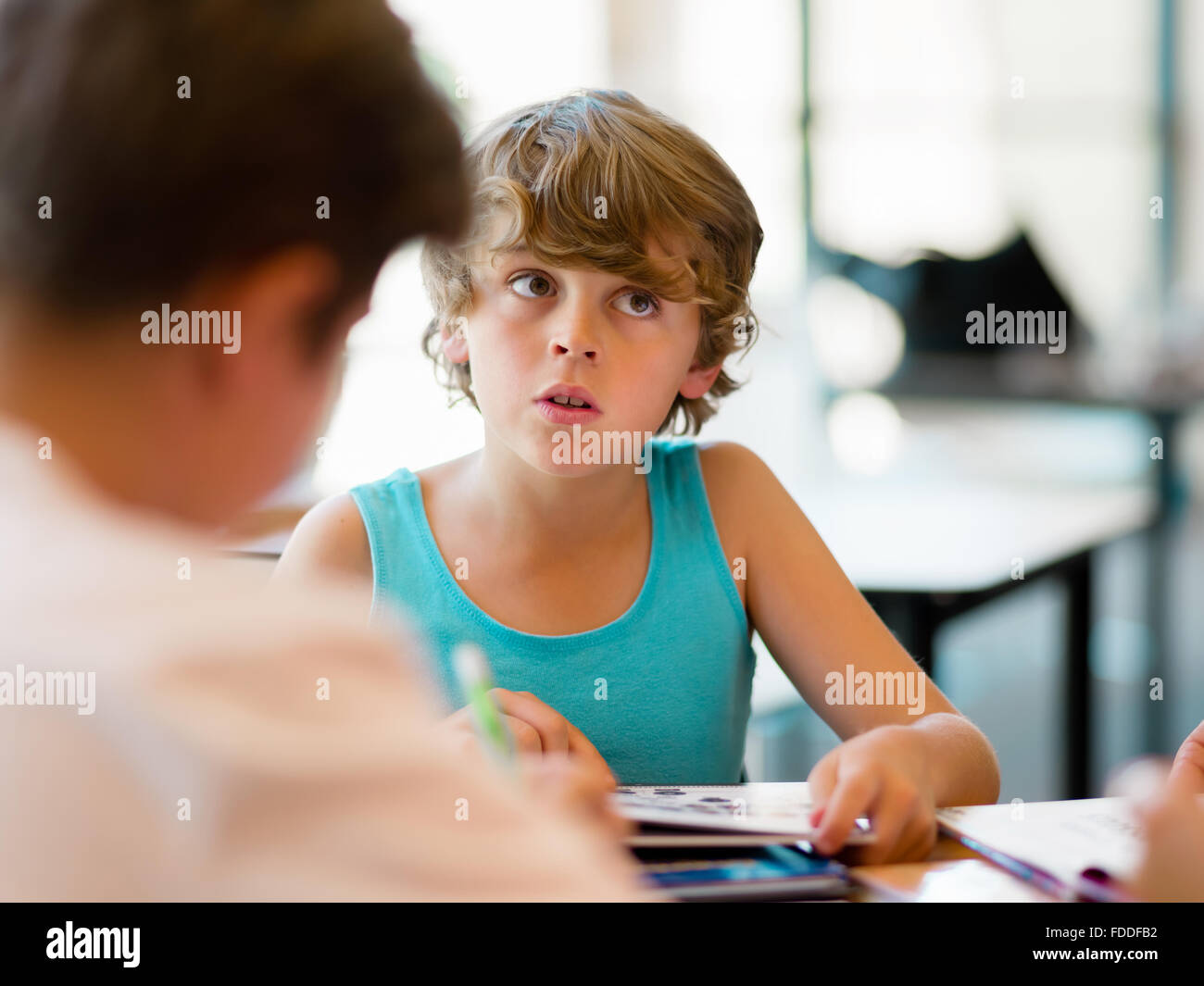 Boy in library with books Stock Photo - Alamy