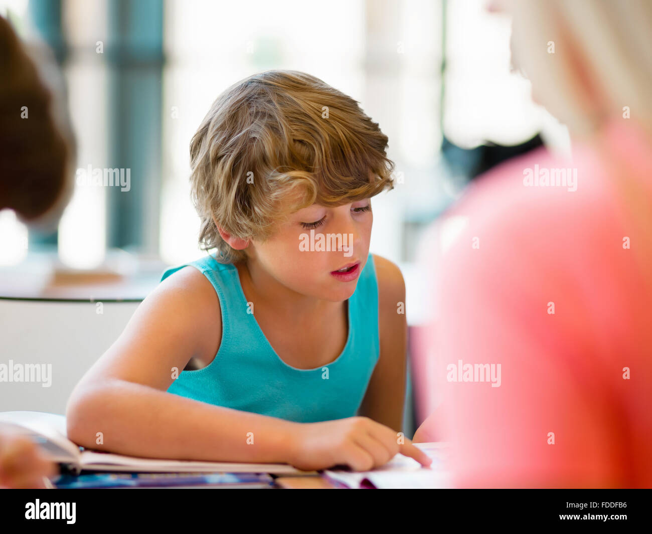 Boy in library with books Stock Photo - Alamy
