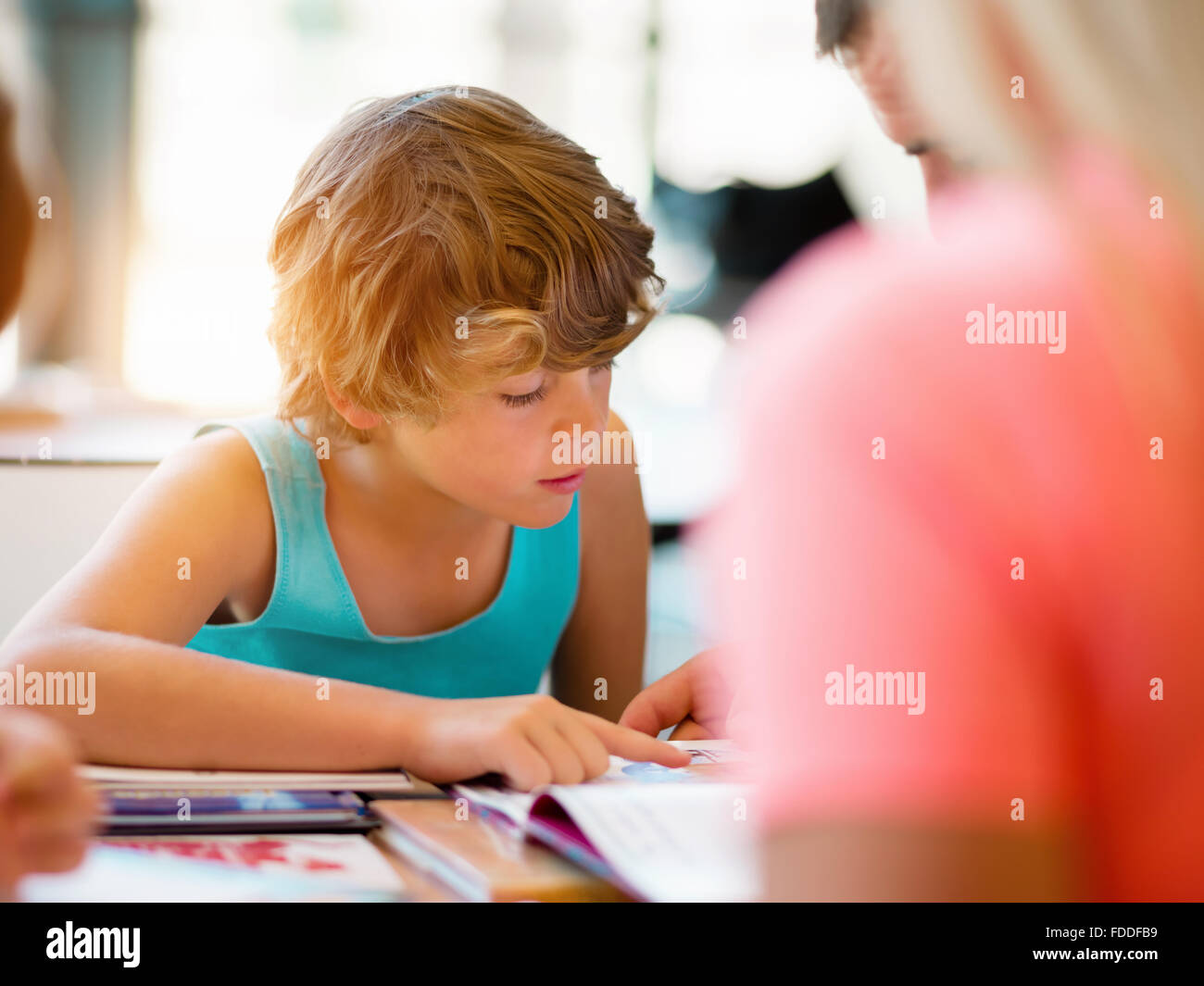 Boy in library with books Stock Photo - Alamy