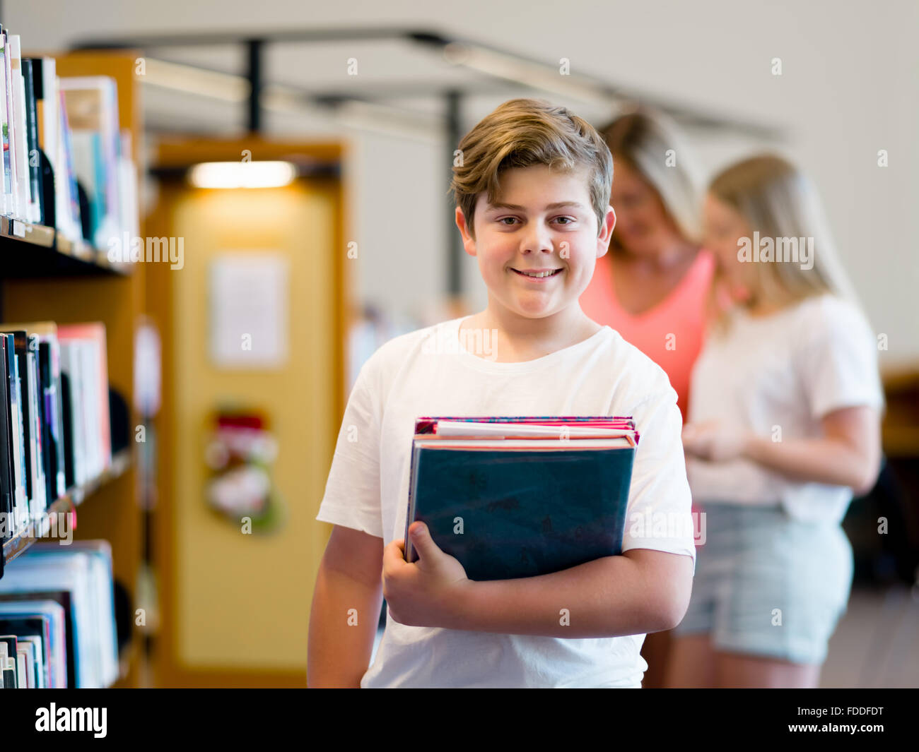 Boy in library choosing books Stock Photo - Alamy