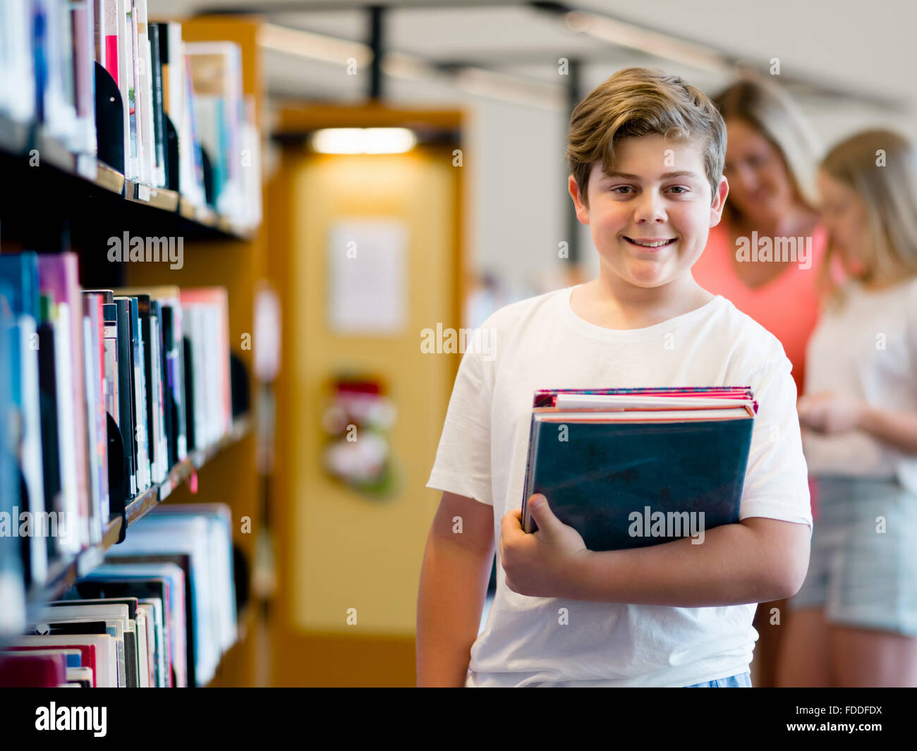 Boy in library choosing books Stock Photo - Alamy