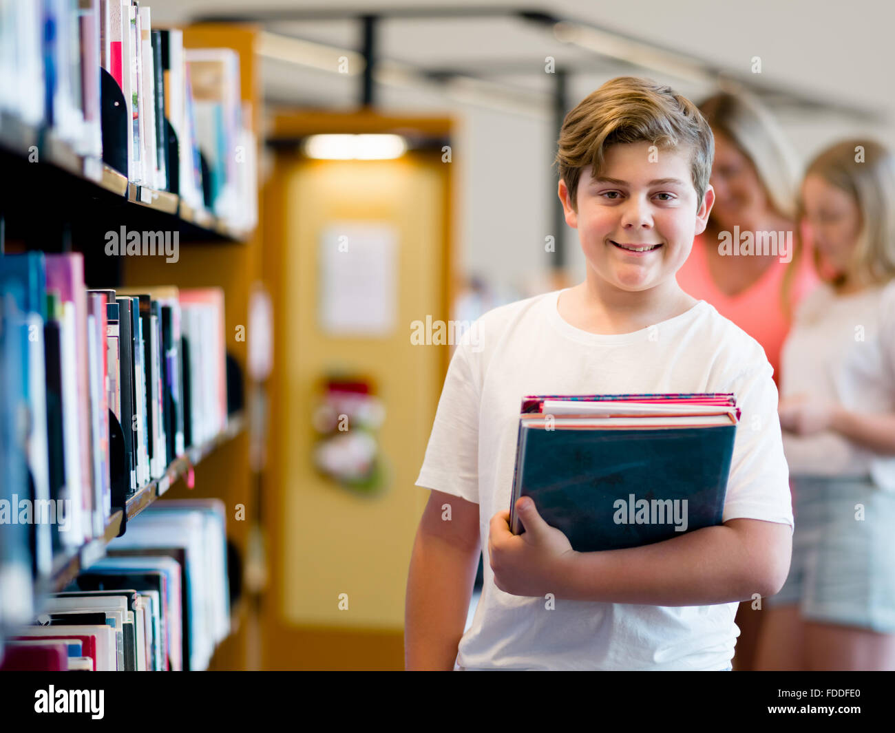 Boy in library choosing books Stock Photo - Alamy