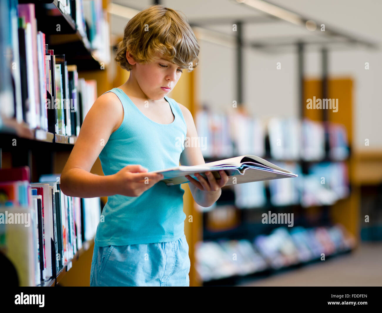 Boy in library choosing books Stock Photo - Alamy