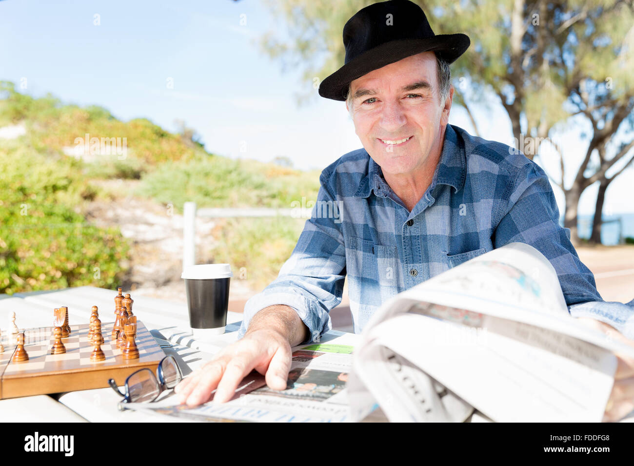 Senior gentleman reading newspaper in park Stock Photo - Alamy