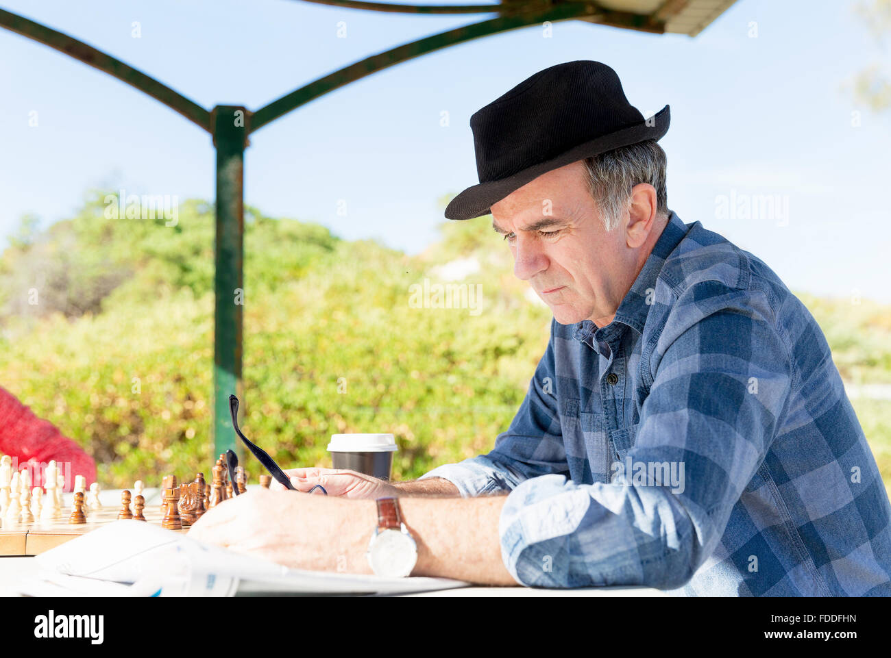 Senior gentleman reading newspaper in park Stock Photo - Alamy