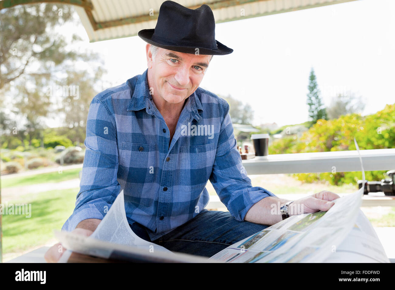 Senior gentleman reading newspaper in park Stock Photo - Alamy