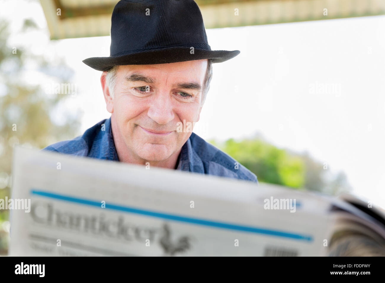 Senior gentleman reading newspaper in park Stock Photo - Alamy