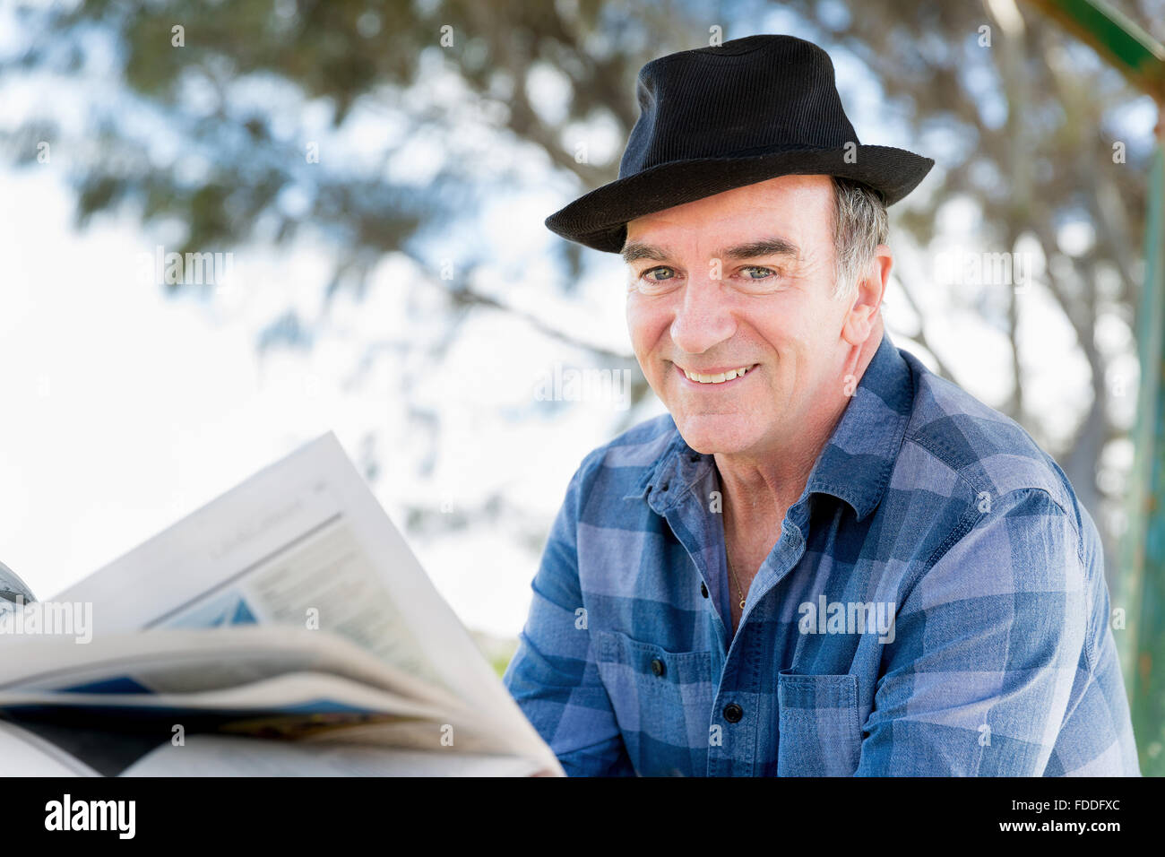 Senior gentleman reading newspaper in park Stock Photo - Alamy